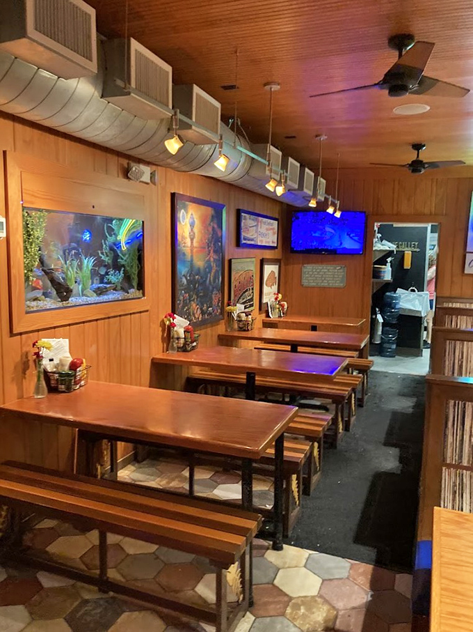 No white tablecloths here—just wooden benches, fish tanks, and the promise of honest food that doesn't need fancy surroundings to impress.