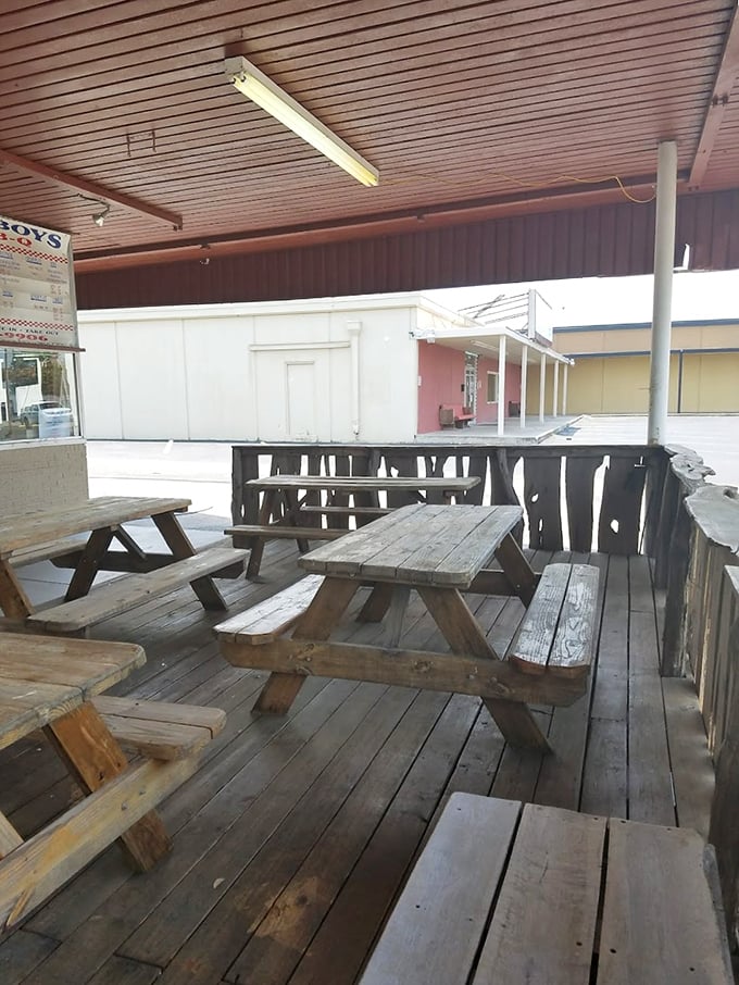 Weathered picnic tables tell stories of countless barbecue pilgrimages. Wood seasoned by time and Texas weather—just like the meat inside.