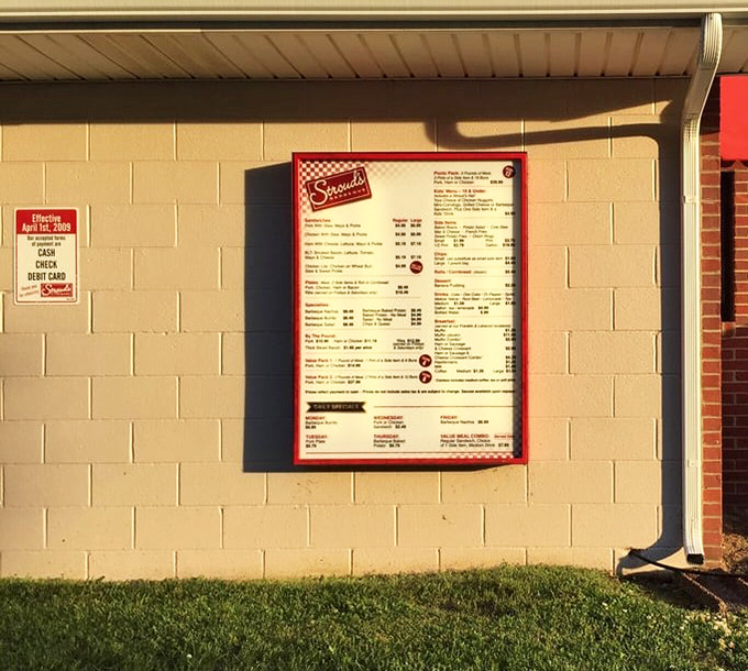 Menu board bathed in golden hour light—a barbecue sunset that promises delicious horizons ahead.