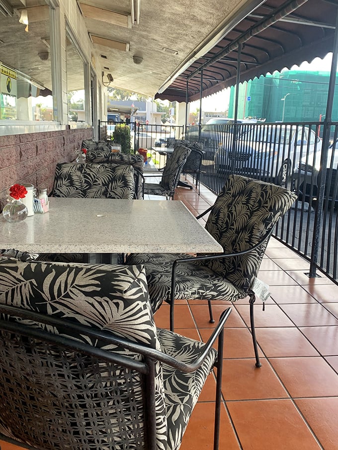 Outdoor seating with tropical-patterned chairs – California sunshine included at no extra charge with every breakfast order.