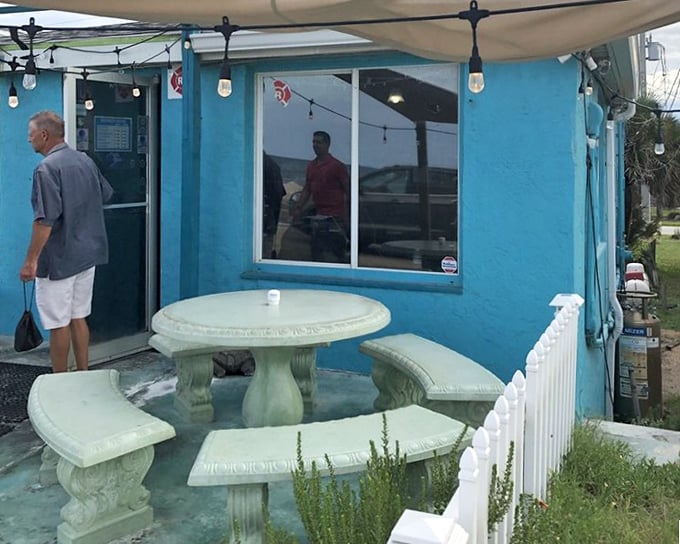 Al fresco dining with coastal charm. This stone table setup offers the perfect perch to enjoy sea breezes with your seafood—nature's perfect pairing.
