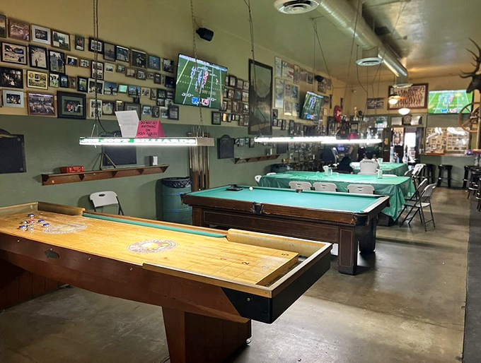 The pool tables stand ready for action under the watchful gaze of countless photographs—silent witnesses to decades of friendly competition and cold beer.