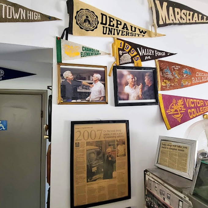 Wall fame that tells stories—college pennants, newspaper clippings, and photographs that chronicle decades of community connections and memorable visitors.
