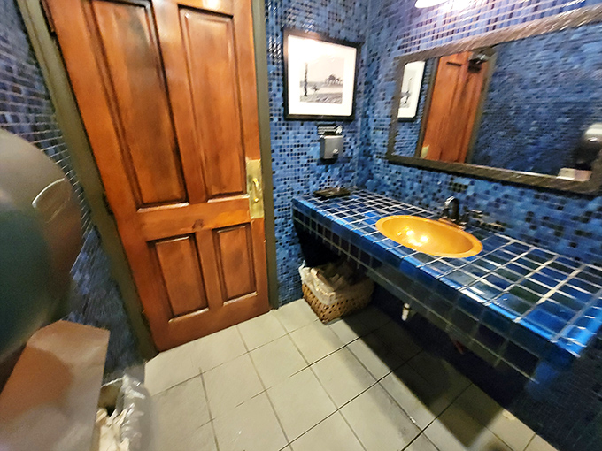 Even the restroom gets the full treatment—blue tile mosaic and warm wood that says, "Yes, we care about every single detail in this place."
