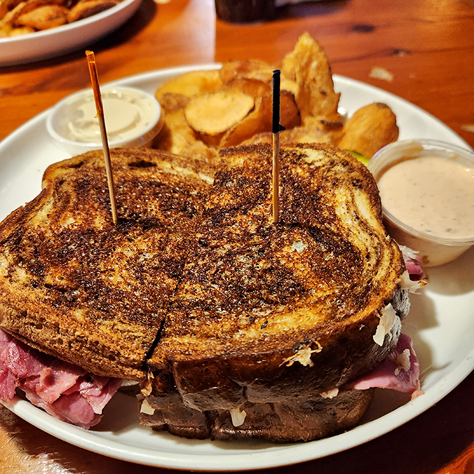 This Reuben sandwich isn't messing around – it's a skyscraper of corned beef and sauerkraut that demands respect and extra napkins.
