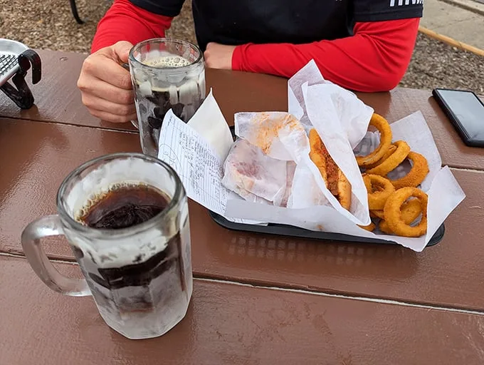 Two frosty mugs of root beer flanking a basket of comfort food—a scene Norman Rockwell would have painted if he'd visited Joliet.