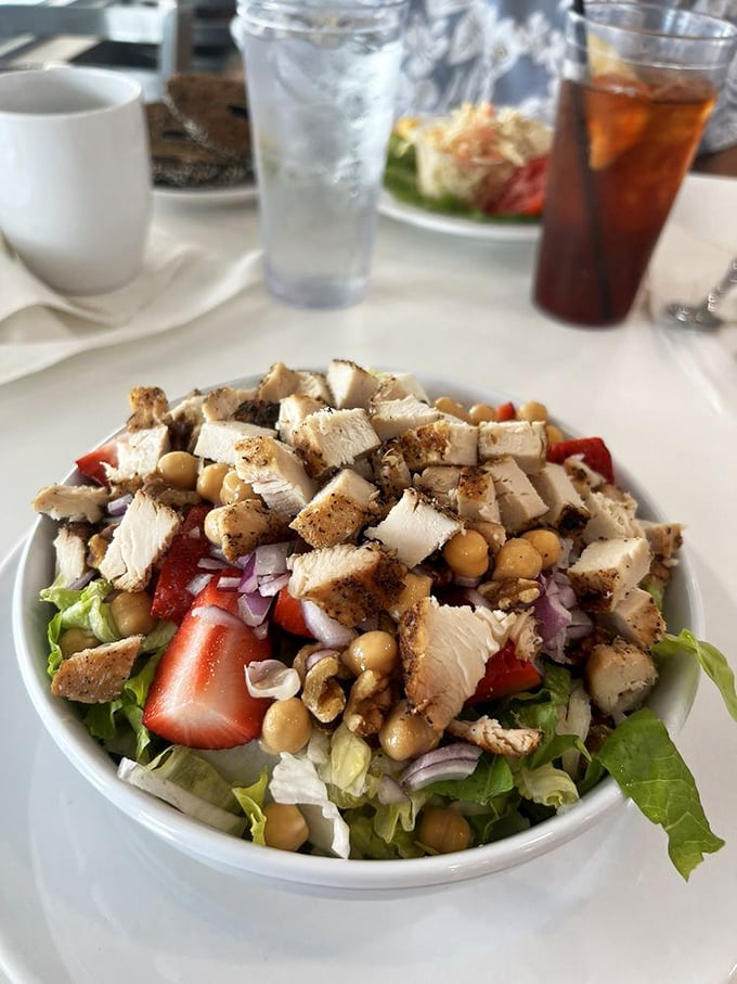 A salad that doesn't feel like punishment—fresh greens, grilled chicken, strawberries, and chickpeas creating a chorus of flavors that might make you forget bacon exists.
