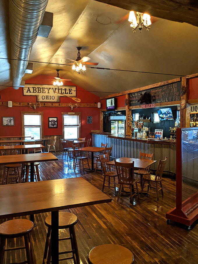 Wooden tables bathed in warm light create that "everybody knows your name" vibe. This isn't just dining—it's community served alongside your brisket.