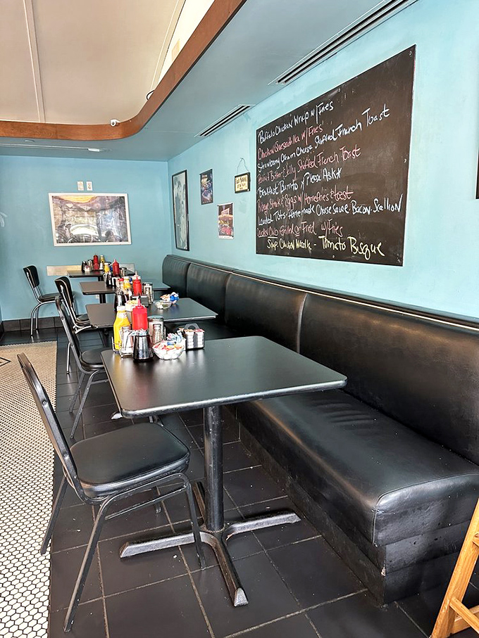 Blue walls, black booths, and a chalkboard menu—the holy trinity of diner décor that says, "Sit down, stay awhile."