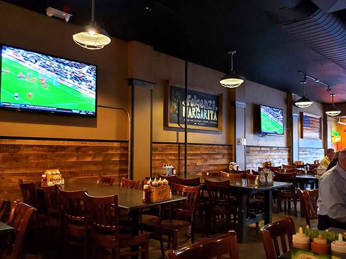 A dining room that invites you to settle in. The wood-paneled walls and comfortable seating suggest you should order another round and stay awhile.