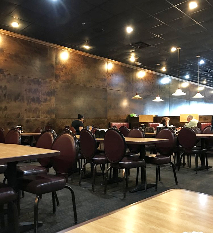 Comfortable seating with warm lighting creates the perfect backdrop for the main event – systematically trying everything on the buffet line.