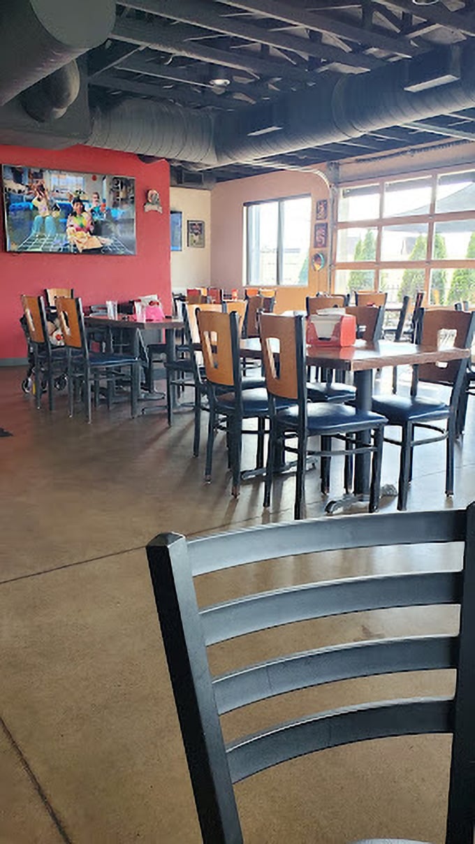 Simple seating that knows its role: stay comfortable but get out of the way of the real star—the food. Those exposed ducts have carried years of tantalizing aromas.