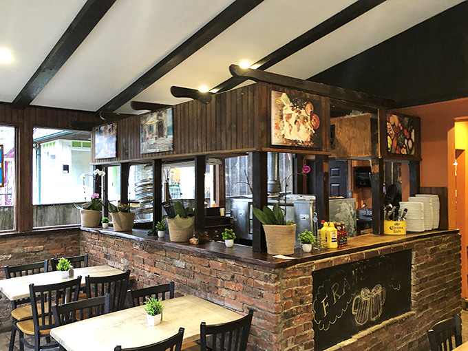 The heart of the operation – brick, wood, and the promise of good things to come from behind those kitchen doors.