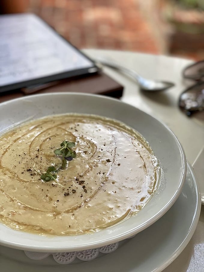 She-crab soup so velvety and rich, it's basically wearing pearls—a creamy celebration of Charleston's coastal bounty.