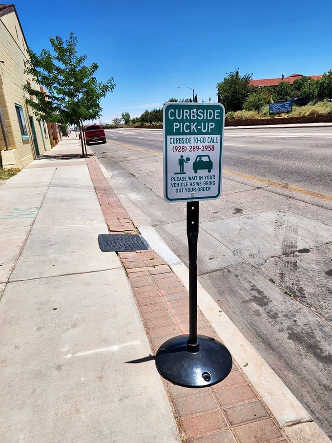 Even the curbside pickup sign has personality – standing sentinel on the sidewalk, promising the same great flavors to go.