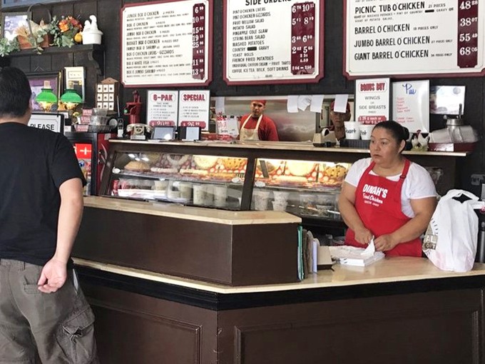 Behind the counter, the real magic happens. These aren't just employees—they're guardians of a fried chicken legacy that spans generations.