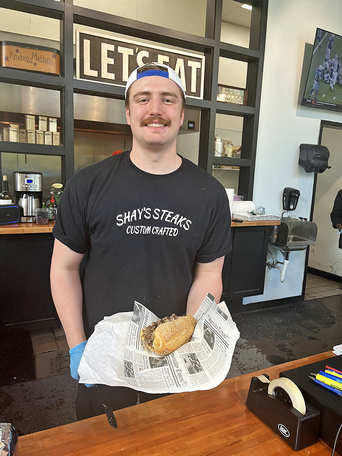 Behind every great cheesesteak is someone who takes pride in their craft—this smile says "I'm about to make your day significantly better."