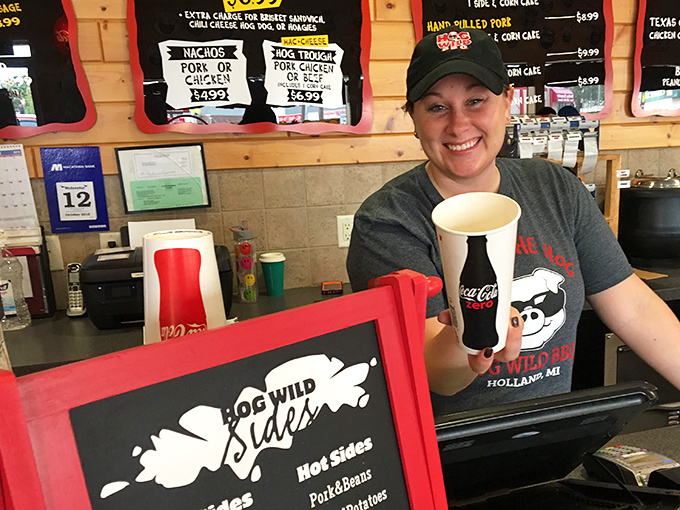 The smile of someone who knows they're about to make your day significantly better with smoked meat and hospitality.