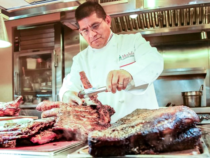 The meat maestro at work, carving with the precision and focus of a surgeon. This is craftsmanship you can taste, one slice at a time.