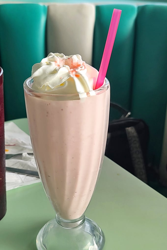 This isn't just a strawberry milkshake—it's dessert masquerading as a beverage. That pink straw is your ticket to childhood bliss.