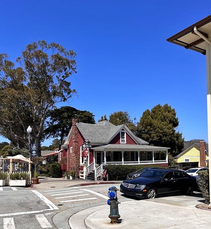 The little red house stands proudly on its corner, a splash of warmth against Pacific Grove's famously blue skies.