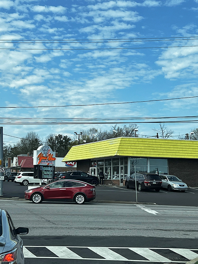Morning in Pennsylvania: blue skies, power lines, and the promise of fresh donuts under that unmistakable yellow roof.