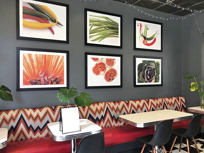 Modern art meets comfort dining with these vibrant vegetable prints—a feast for the eyes before the actual feast arrives.