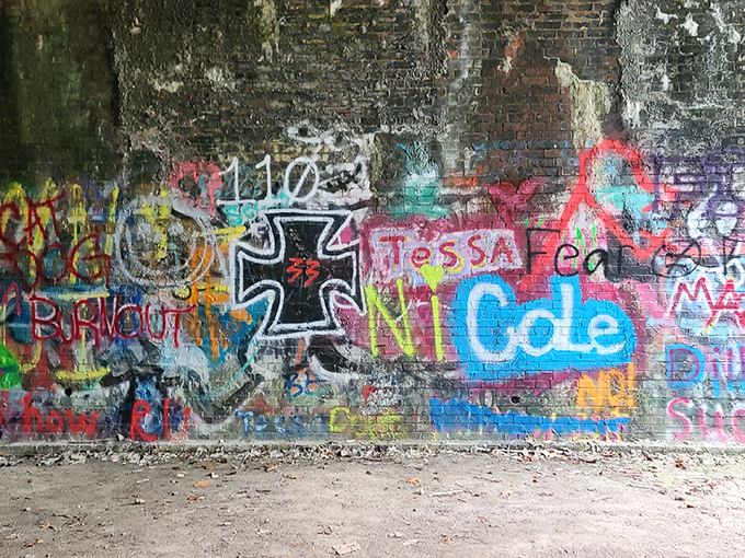 Layers of colorful graffiti create an unexpected art gallery inside the tunnel, each tag a modern signature on historic stone.