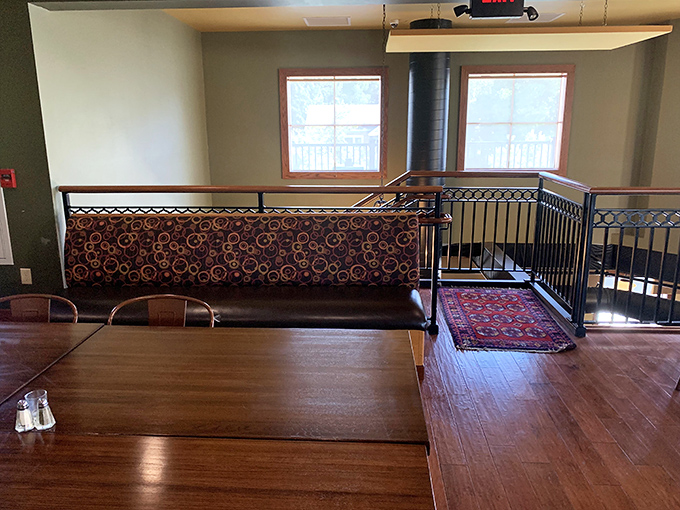 The upper dining level offers additional seating with the same warm, welcoming atmosphere throughout.