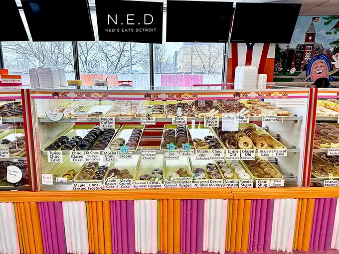 The display case stretches seemingly into infinity, a Willy Wonka-esque wonderland of fried dough possibilities.