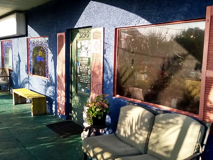 The entrance says, "Come as you are, leave significantly happier." Those mosaic-framed windows aren't just decorative—they're portals to flavor country.