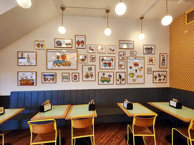 Whimsical food-themed artwork creates a gallery wall of joy. Like dining in the home of a friend who has impeccable taste and a sense of humor.