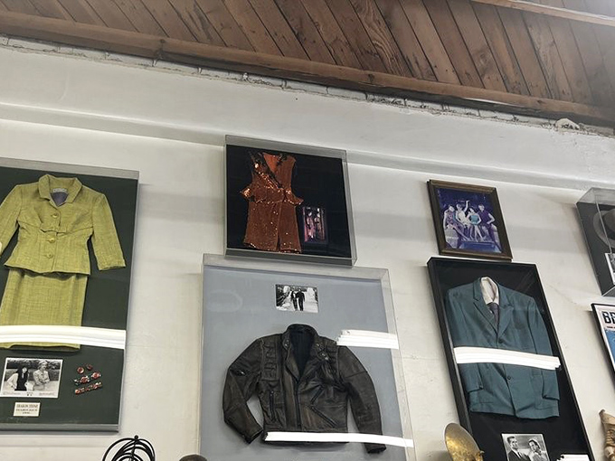 The wall of fame displays particularly notable costume pieces in shadow boxes, complete with production stills—museum-worthy memorabilia at thrift store prices.