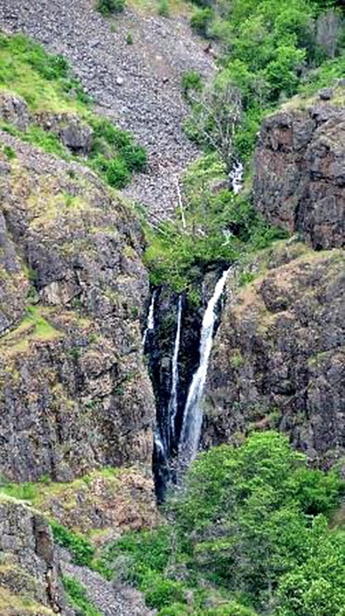 Hidden waterfalls tumble down rocky cliffs like nature's own private spectacular light show.