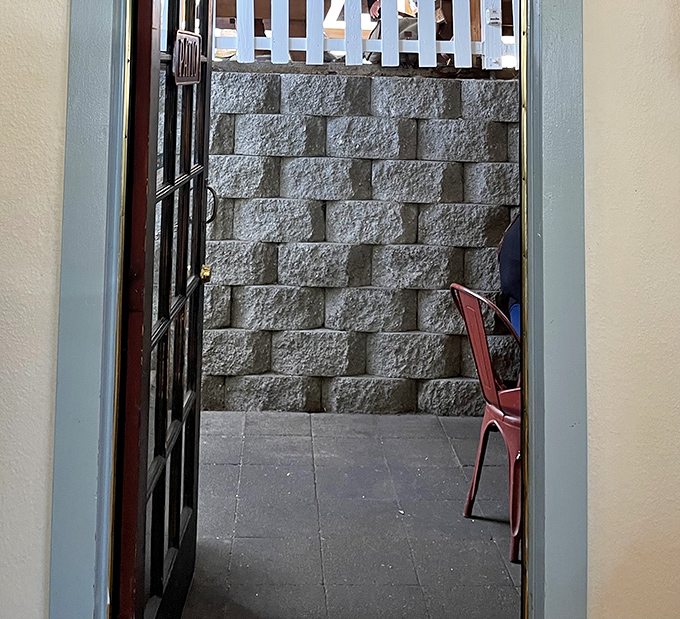 This passageway doesn't just lead to a patio—it's a portal to the outdoor breakfast dimension where fresh air enhances maple syrup by 27%.
