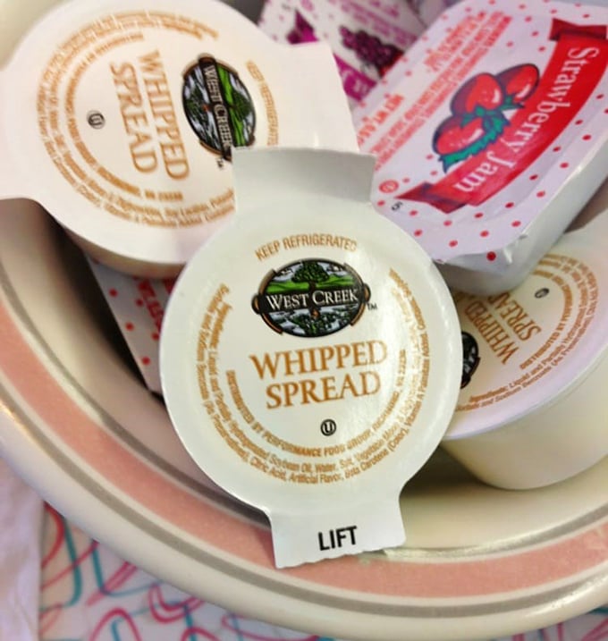 The humble heroes of breakfast—little cups of whipped spread waiting for their moment to shine on warm toast or pancakes.