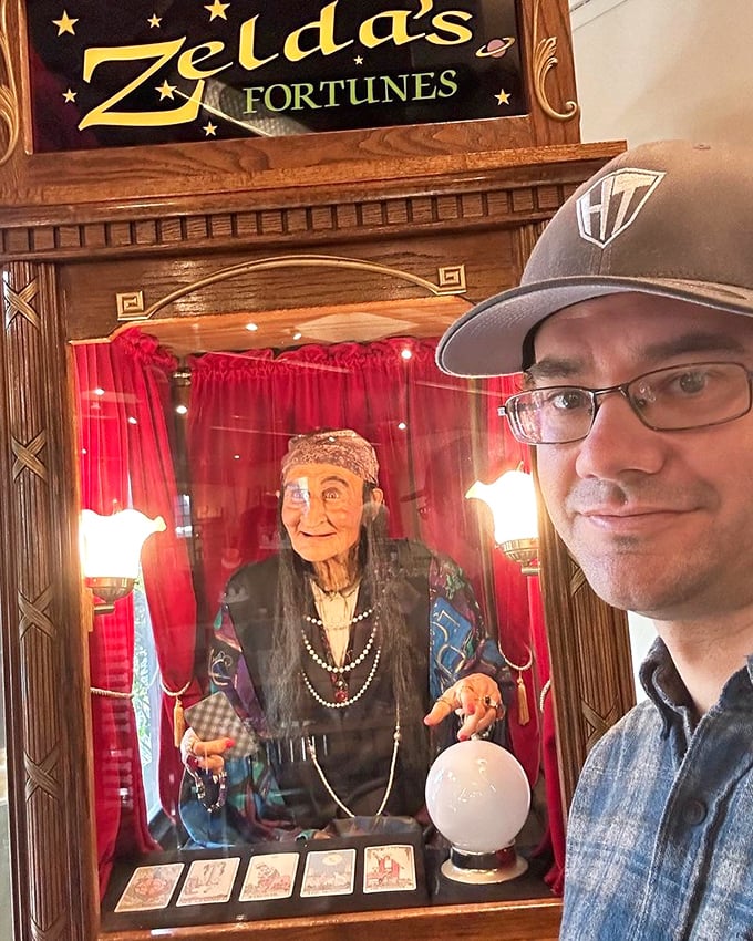 Zelda's mechanical fortune teller offers cryptic predictions—though none as strange as the house's actual history of continuous construction.