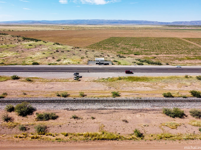 From this height, Prada Marfa appears as a tiny white dot—a minimalist punctuation mark on the run-on sentence of the Texas landscape.