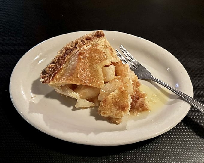 Apple pie that doesn't need to announce itself as homemade – the golden crust and generous filling speak volumes without saying a word.