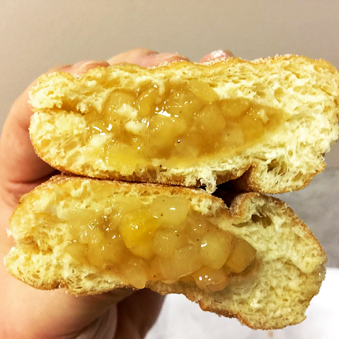 Cut open an apple-filled donut and witness the miracle – tender chunks of cinnamon-spiced fruit nestled in a pocket of fried perfection.