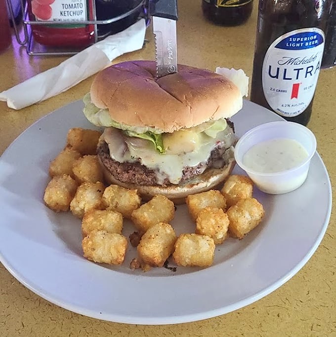 Tater tots playing sidekick to a burger that means business – childhood meets adulthood on one glorious plate.