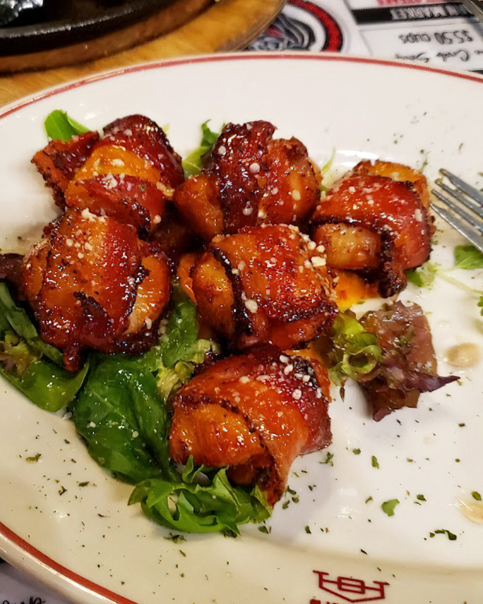 These bacon-wrapped delights aren't just appetizers—they're a preview of the kitchen's commitment to excellence. Sweet scallops and savory bacon create the perfect flavor tango.