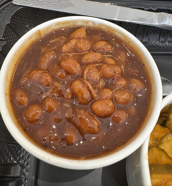 Baked beans swimming with bits of meat—not just a side dish, but a supporting actor worthy of its own award.