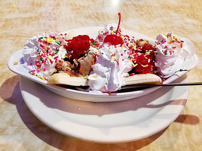 Banana split extravaganza! When whipped cream mountains meet sprinkle valleys, with cherries standing sentinel over this sweet terrain of childhood joy.