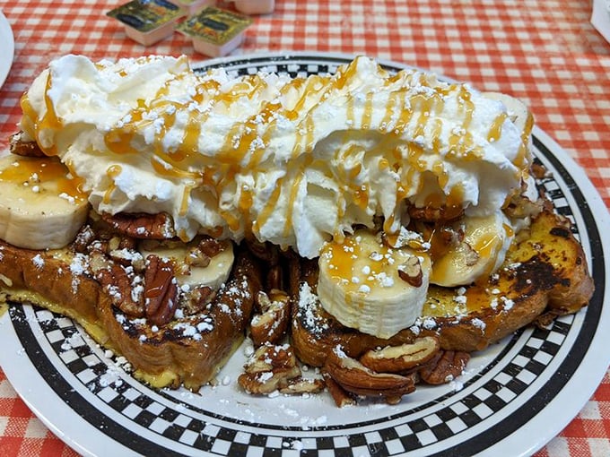 French toast elevated to dessert status with whipped cream mountains and caramel rivers. Breakfast or art installation? You decide.