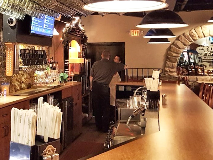 Behind every great brewpub is a bar area where magic happens—stone arches framing bottles like artwork in a museum dedicated to good times.