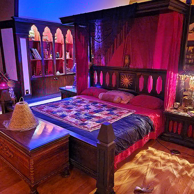 The four-poster bed draped in rich fabrics offers a sumptuous retreat, though you might wonder who else has sought rest in this chamber.