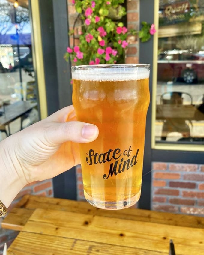 Golden beer in branded glassware—the universal signal that you've found your new favorite local spot. Resistance is futile.