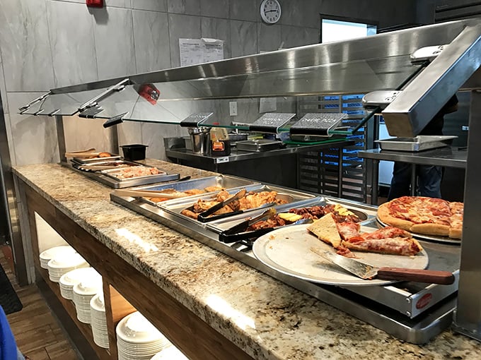 Hot food station featuring pizza and more – because sometimes you need a slice of comfort alongside your culinary adventure.