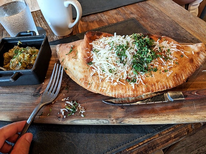A calzone that makes pizza feel underdressed. Golden-brown crust cradling molten cheese and savory fillings – the sleeping bag of comfort food.